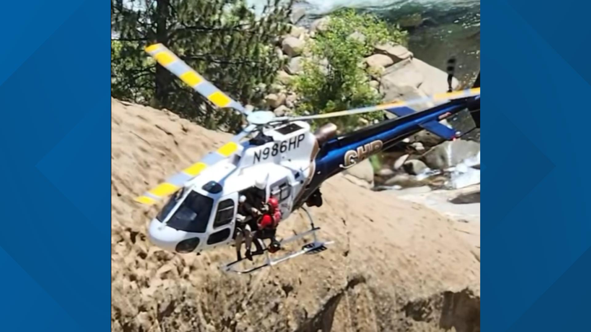 Helicopter team rescues man trapped behind California waterfall | cbs19.tv