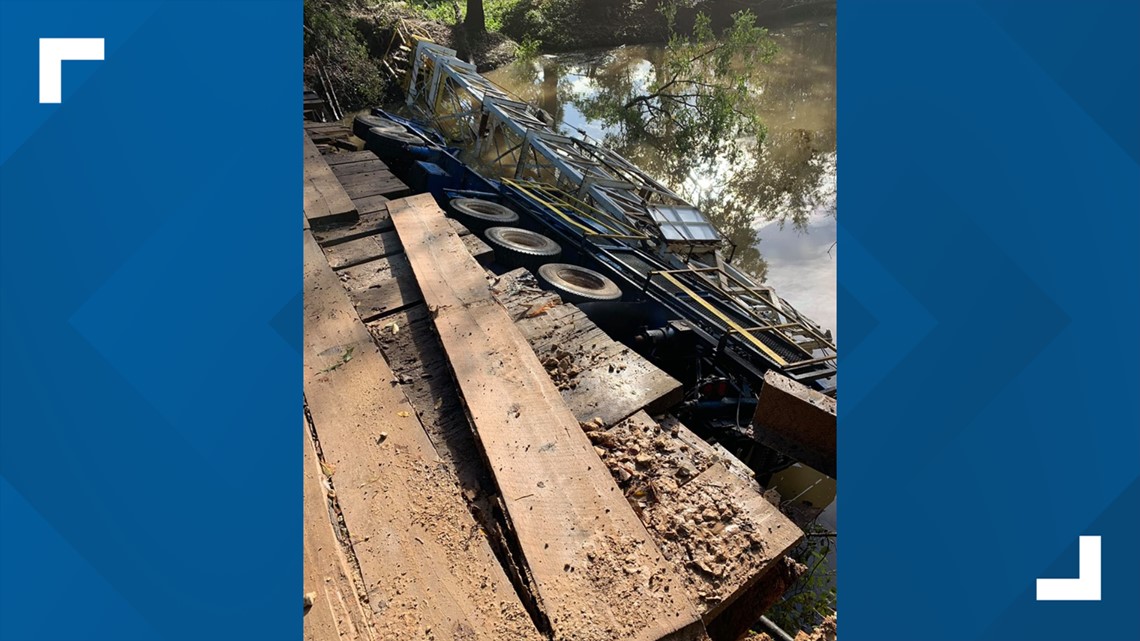 Firefighters help rescue truck driver whose truck fell off narrow ...