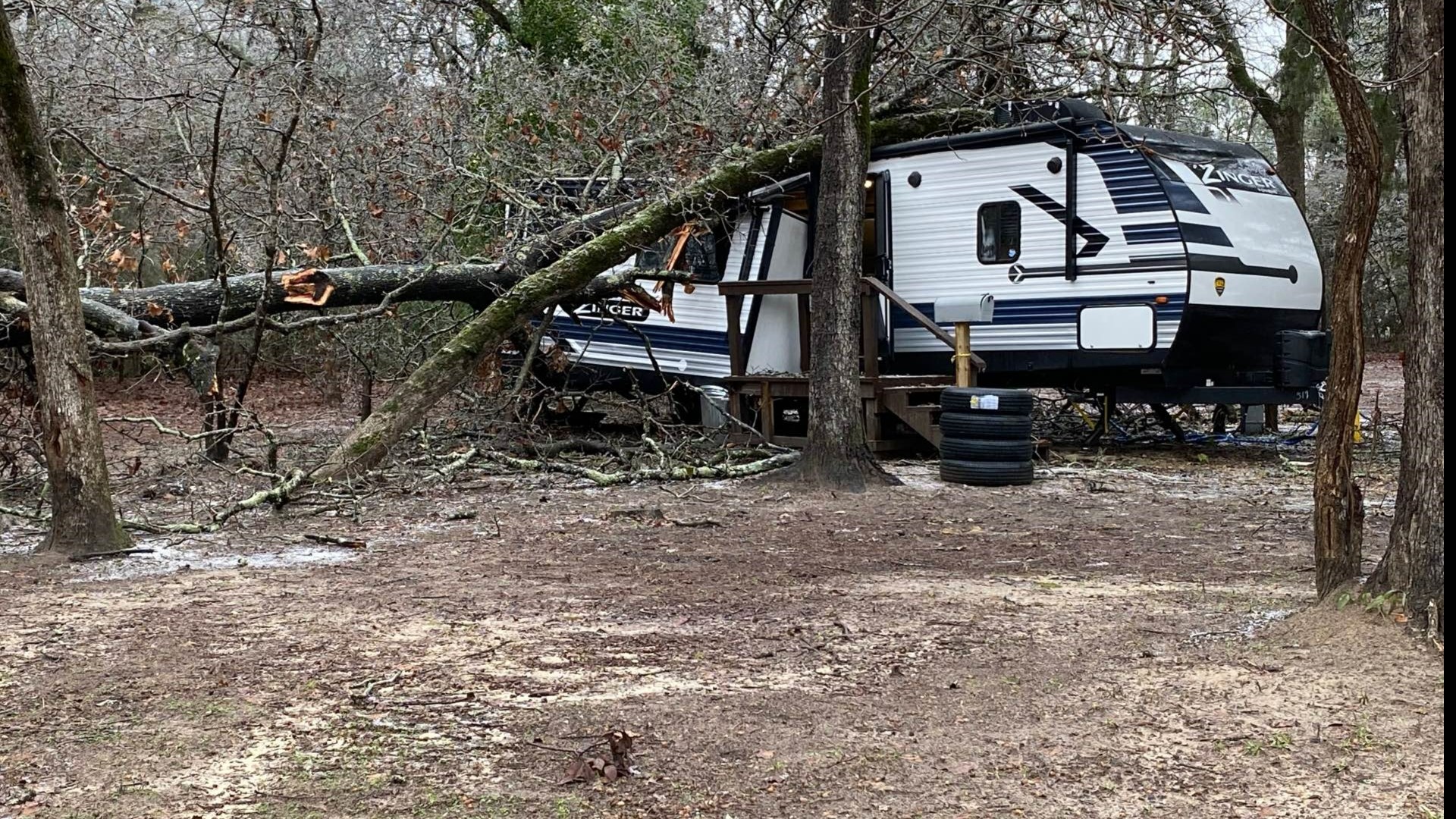 Tyler crews working on a fallen tree on a house | cbs19.tv